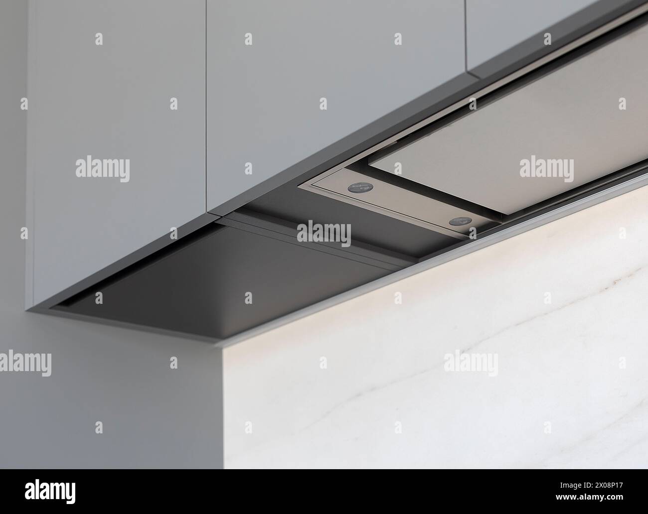 An elegant and contemporary kitchen extractor hood integrated into a ...