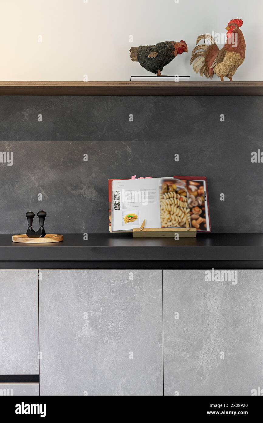 Modern kitchen with decorative chicken figures on a shelf and an open ...