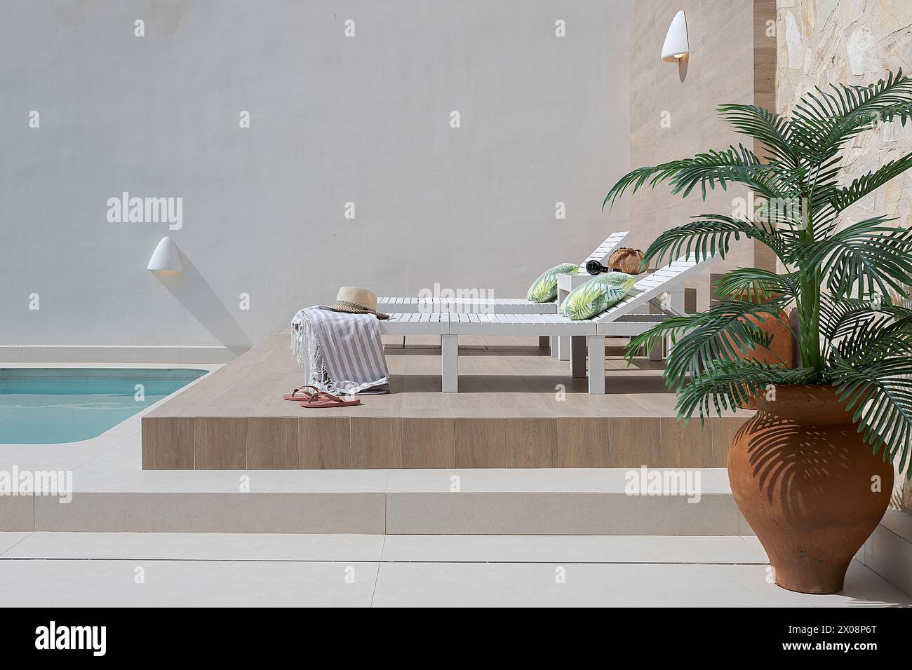 Serene poolside scene loungers palm hi-res stock photography and images ...
