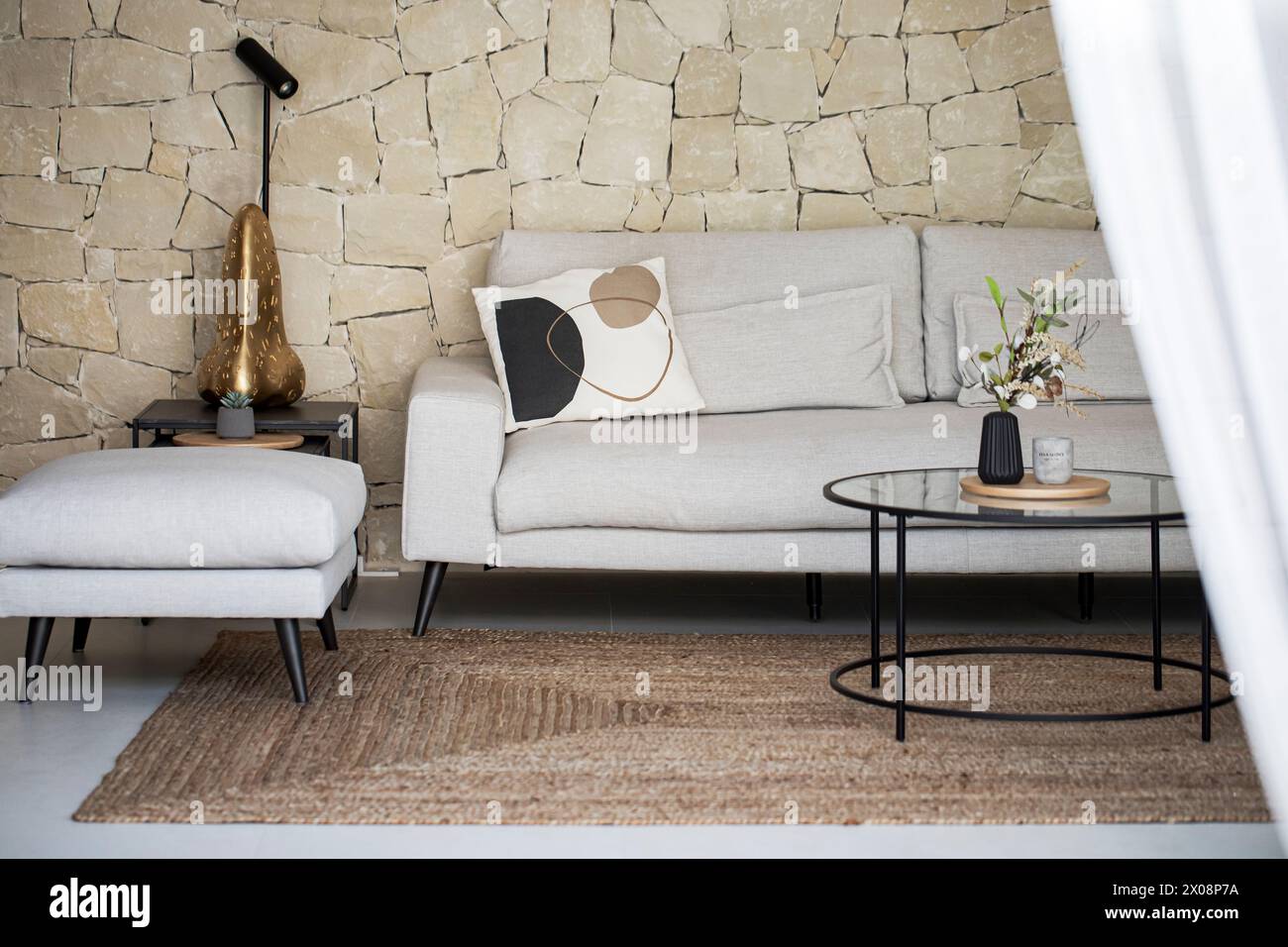 Contemporary living room design featuring a plush gray sofa, chic stone ...