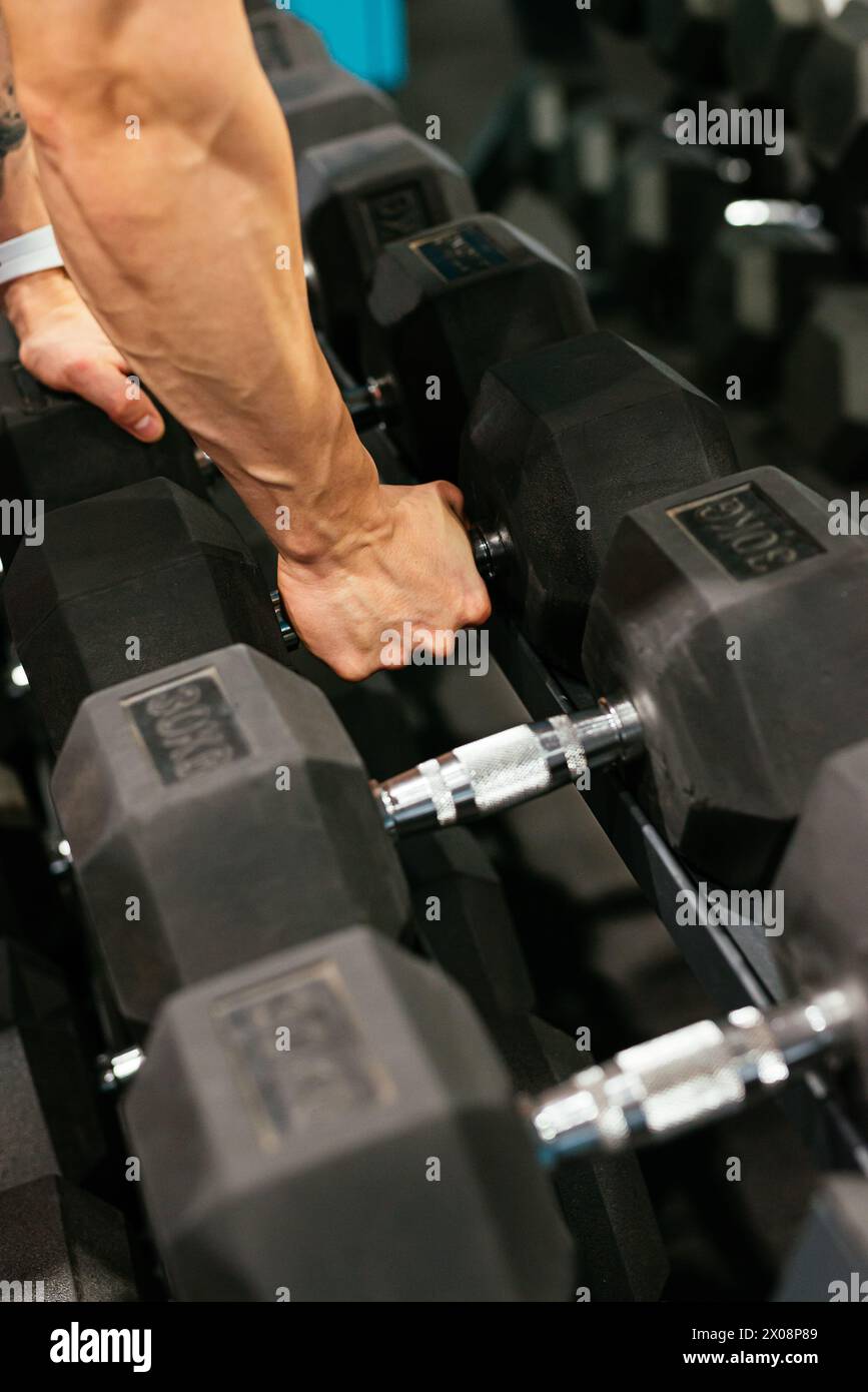 A young cropped unrecognizable man's arm, showing defined muscles, as ...