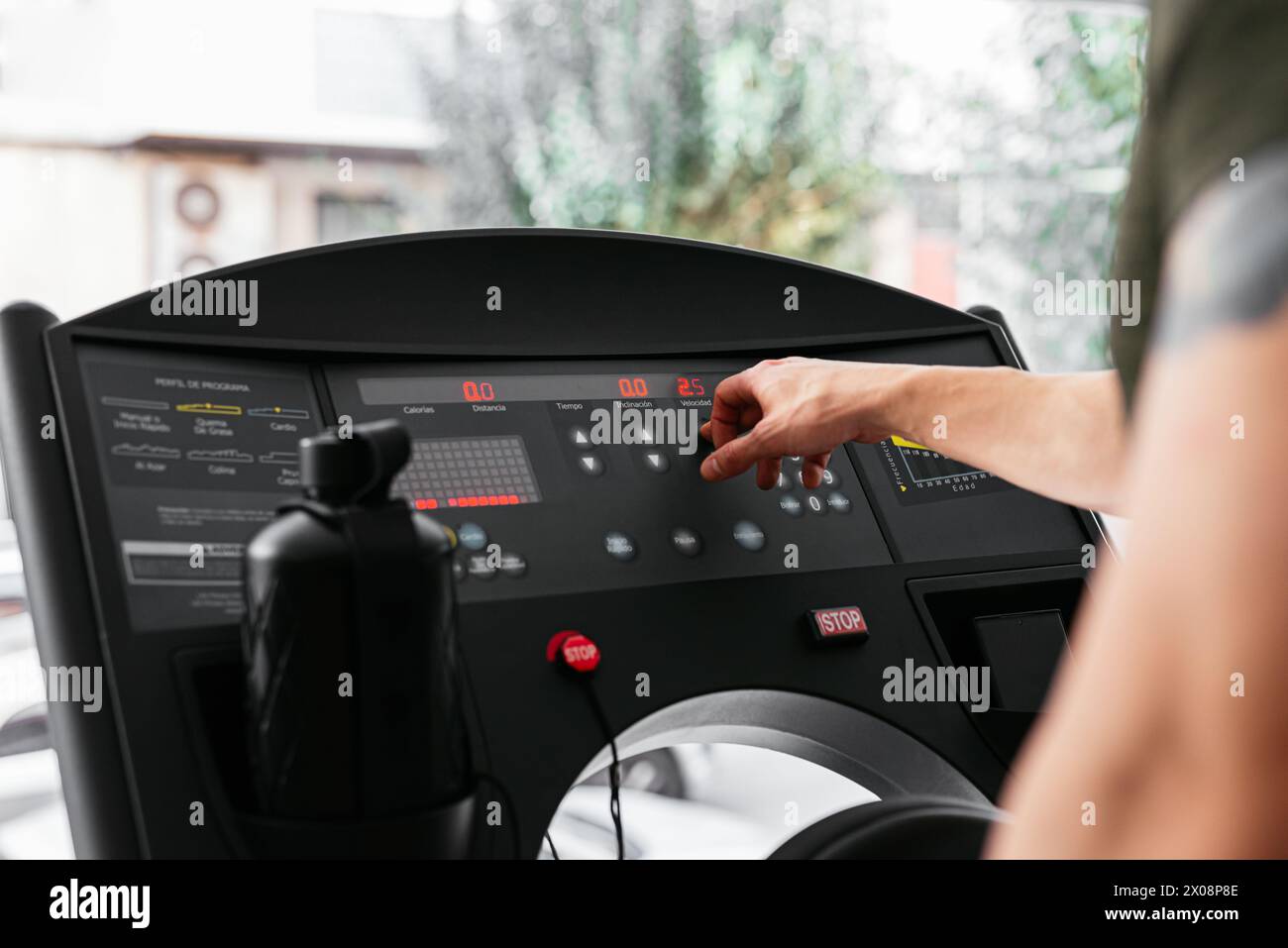A focused young man is shown fine-tuning the control panel of a ...