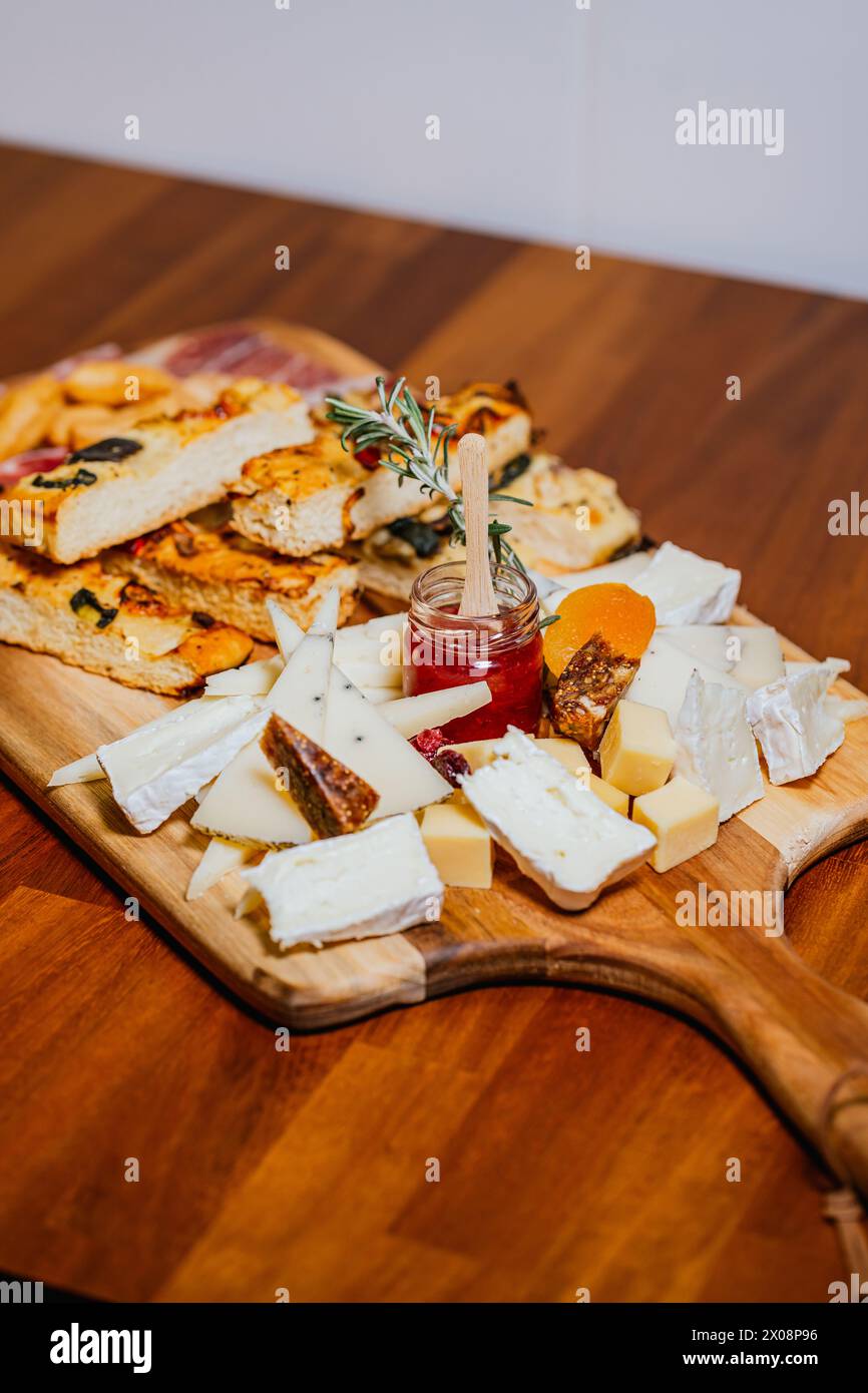 An inviting cheese board laden with an assortment of cheeses, crackers ...