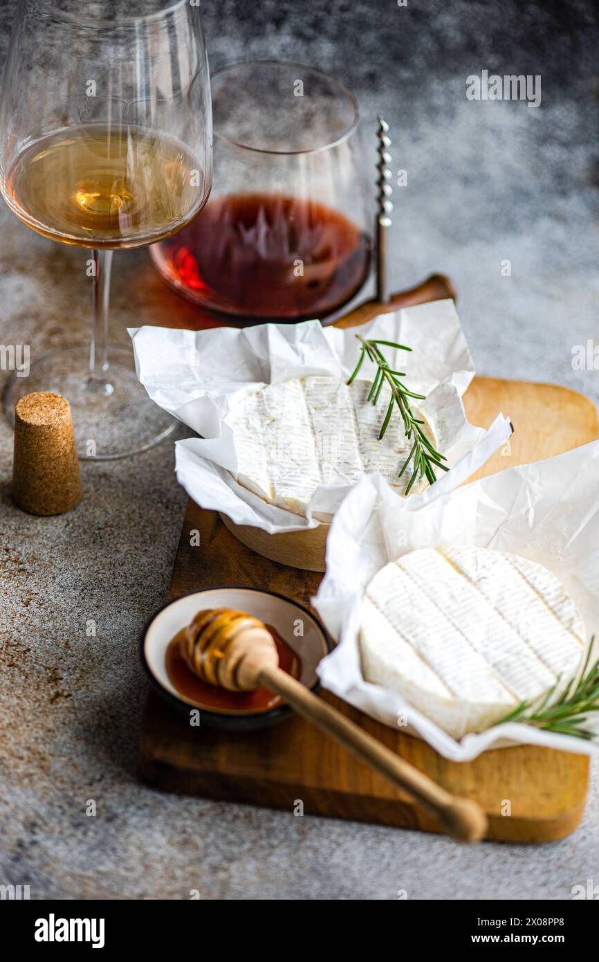 An exquisite display of Brie cheese complemented by honey, rosemary ...