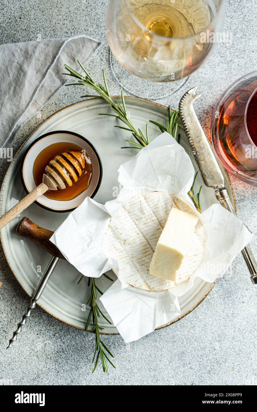 Top view of an elegant display of Brie cheese accompanied by honey ...
