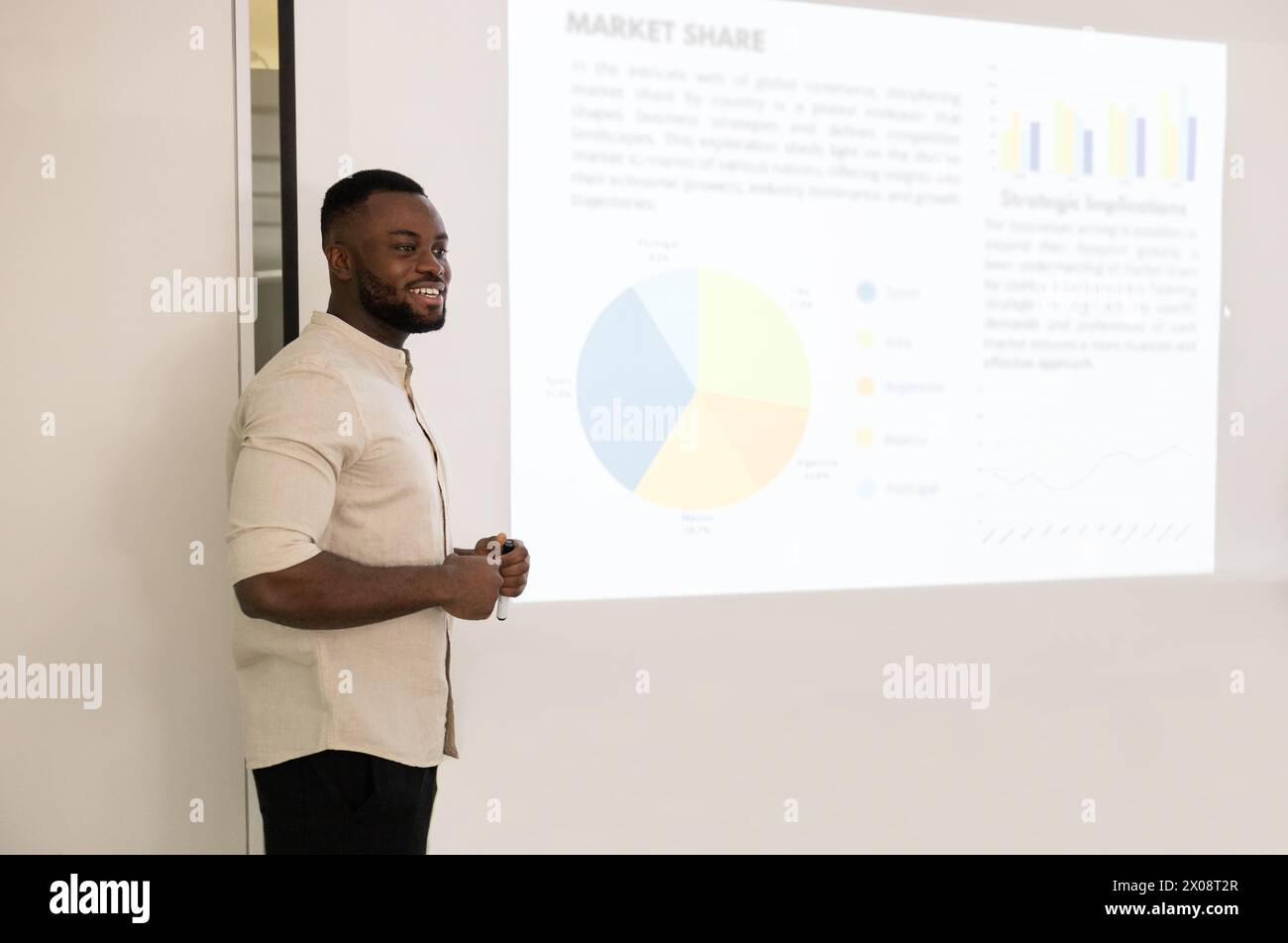 African American man smiling at the camera while giving a business ...