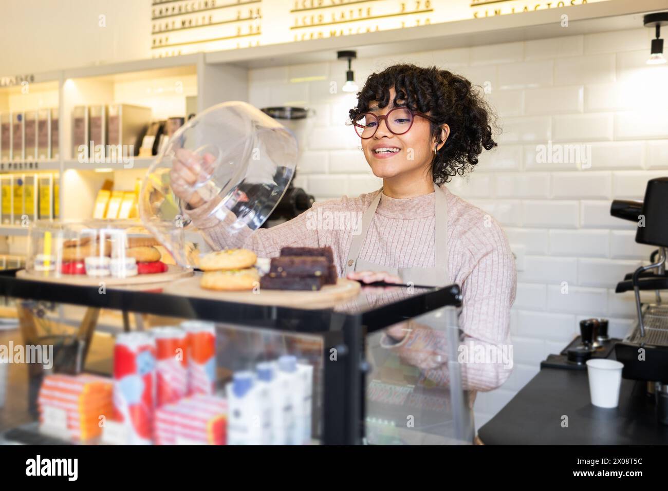 Woman smiling behind bakery counter hi-res stock photography and images ...
