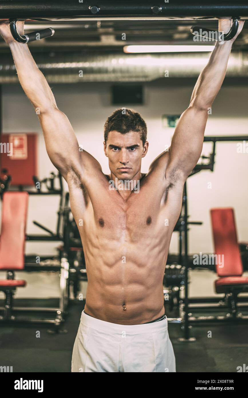 Muscular man doing chin-ups Stock Photo - Alamy