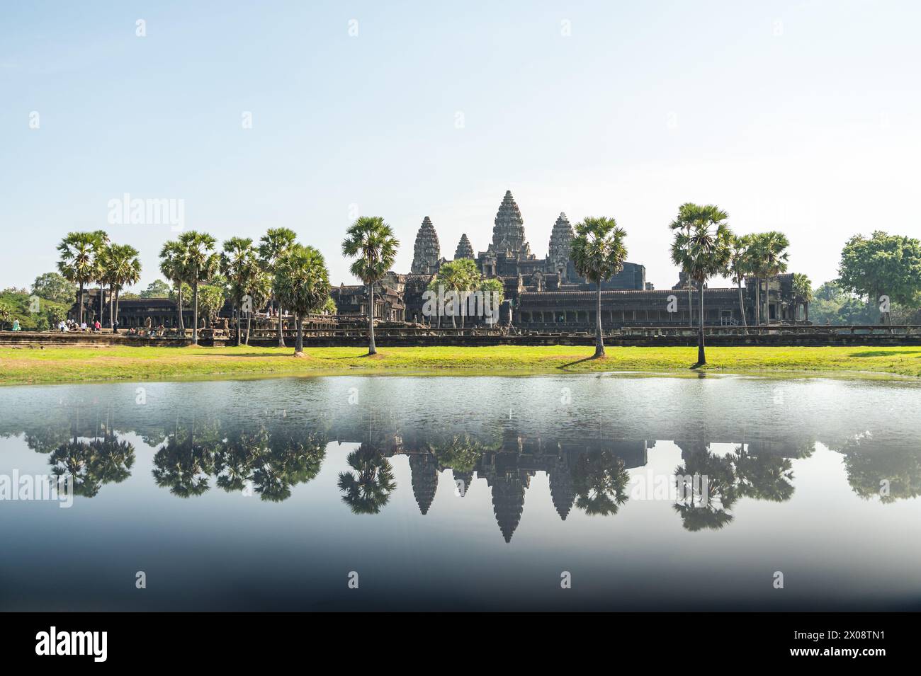Majestic view of Angkor Wat temple across the reflective waters, with ...