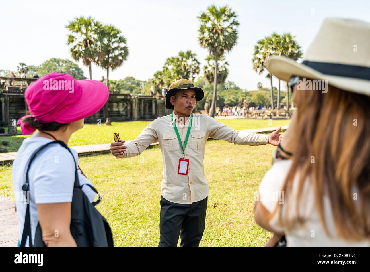 A knowledgeable tour guide is gesturing while explaining the history of ...