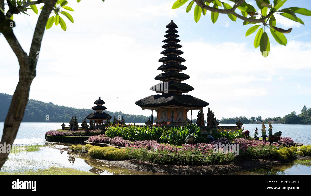 Pura Ulun Danu Bratan Temple in Bali, surrounded by water and flowers ...