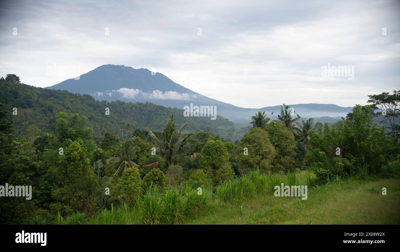A serene landscape featuring Bali's iconic Mount Agung towering over ...