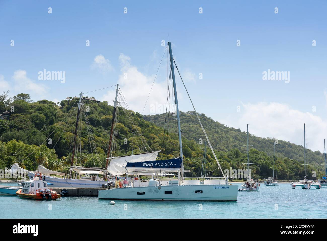 Sailing yachts moored in Britannia Bay, Lovell Village, Mustique Island ...