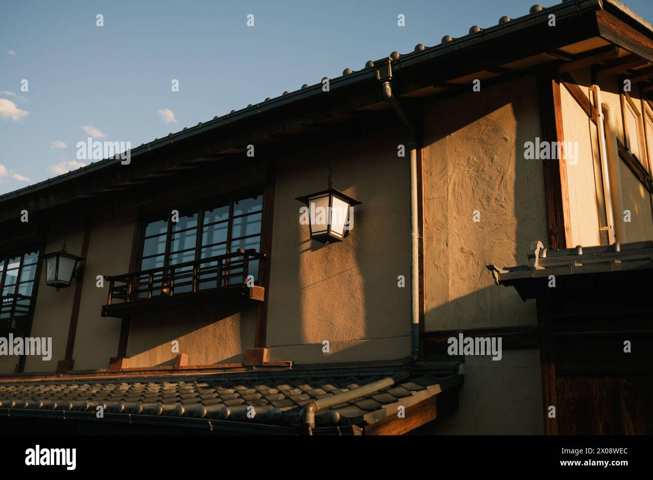 Traditional Japanese architecture basked in warm sunset light ...