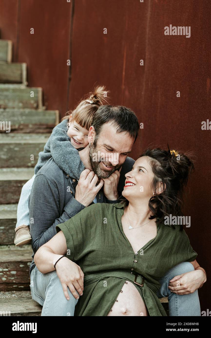 A joyous family moment featuring a laughing child piggybacking on the ...