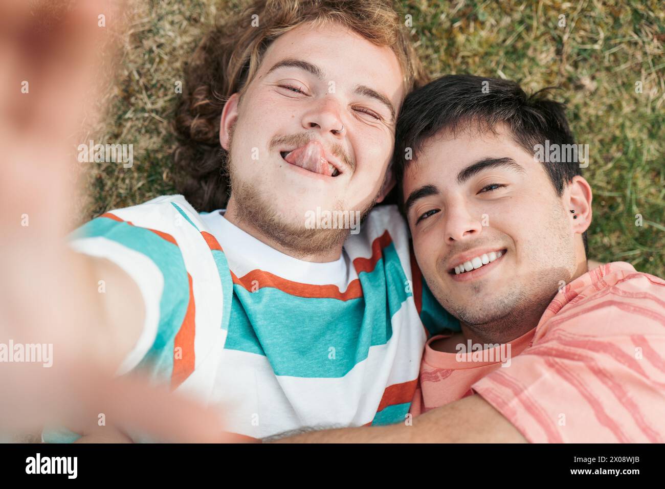 A tender moment of eye contact and smiles shared between a gay couple ...