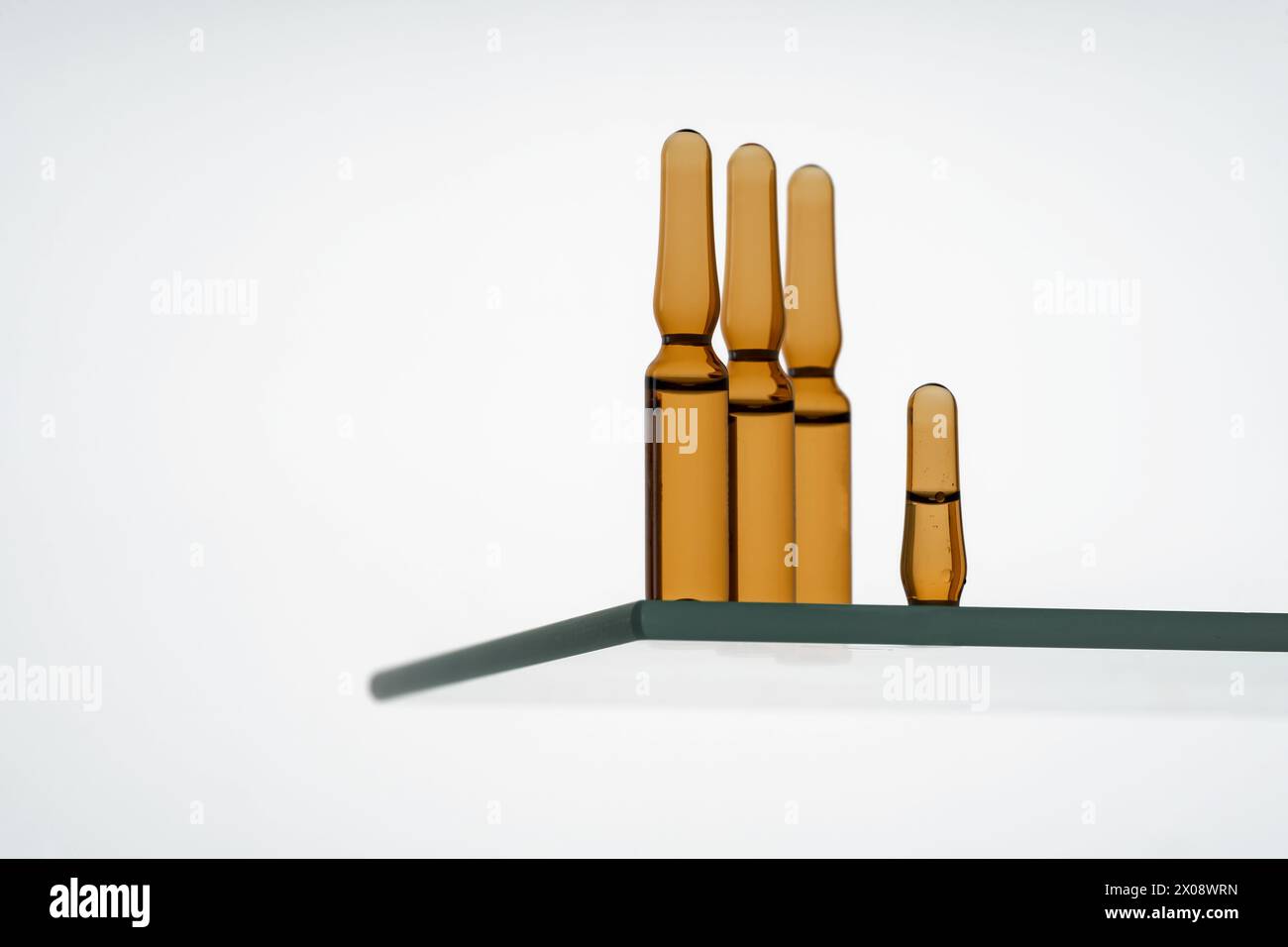 Concentrated face and hair serum in glass ampoules for smoothing ...