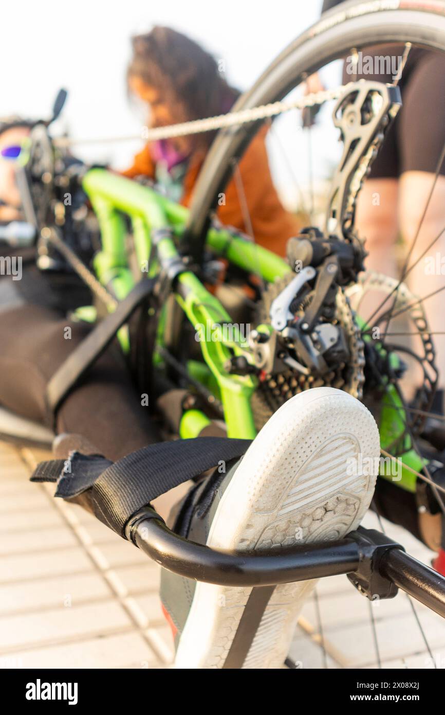 Focus on an unrecognizable handbike as a determined female athlete gets ...