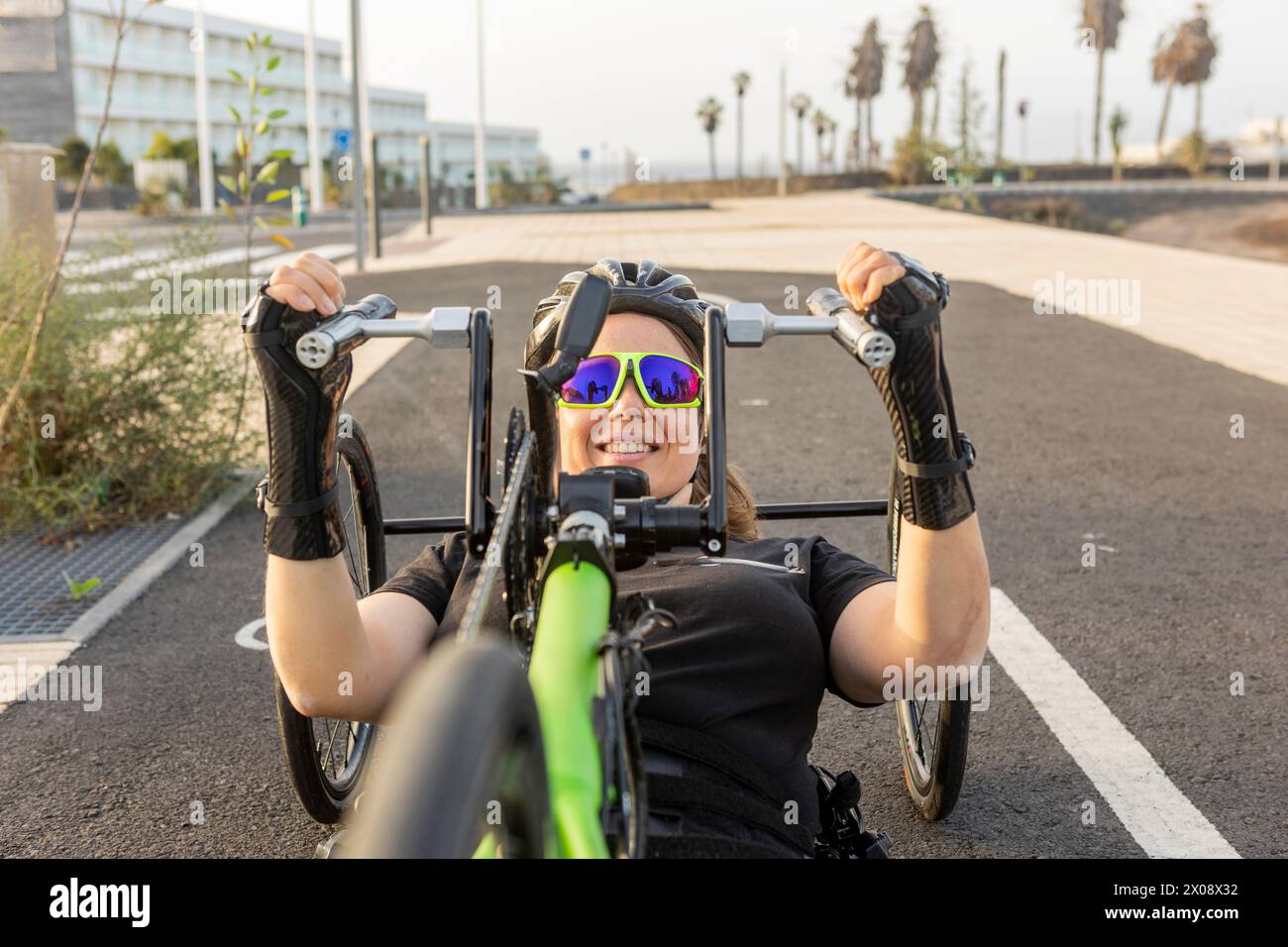 An enthusiastic female Paralympic athlete smiles while training on her ...