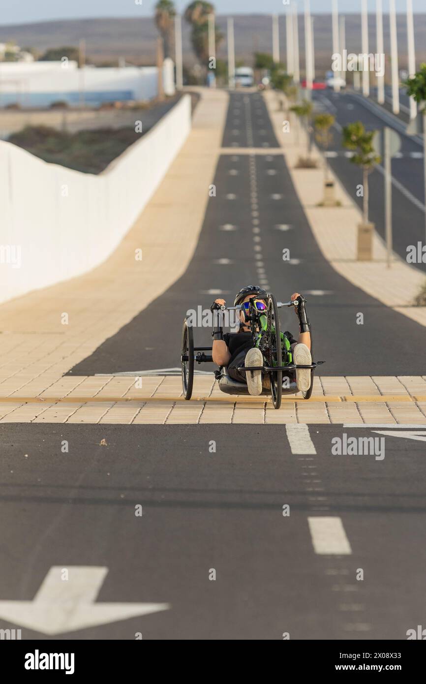Determined unrecognizable female athlete with a disability racing in a ...