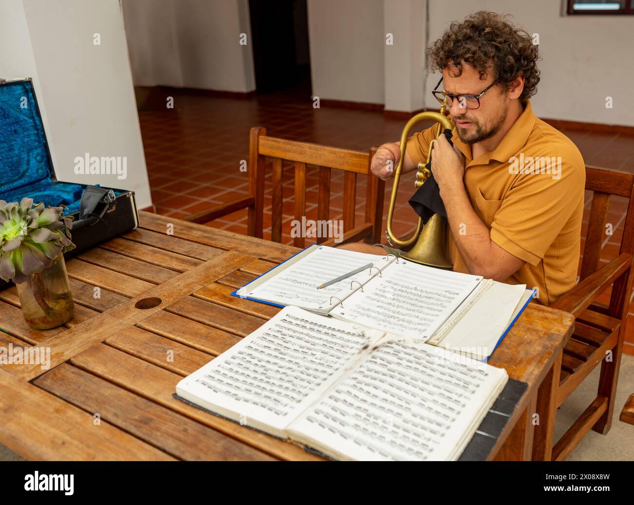 A man with one arm practices the trumpet, reflecting on his music ...
