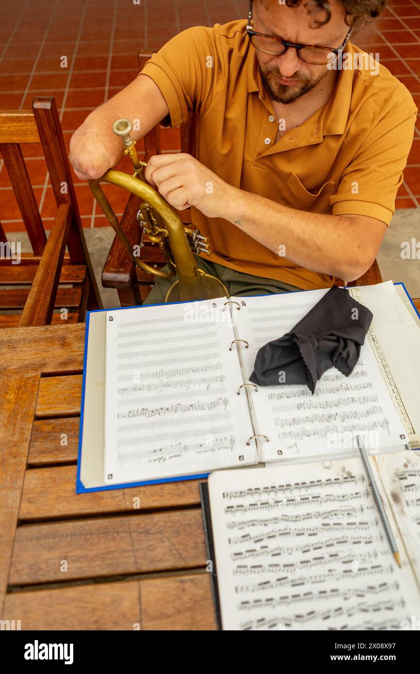 A man with one arm is captured in the midst of his creative process ...