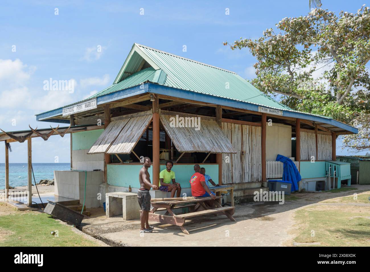 Fishermen at the local fish market in Britannia Bay, Lovell Village ...