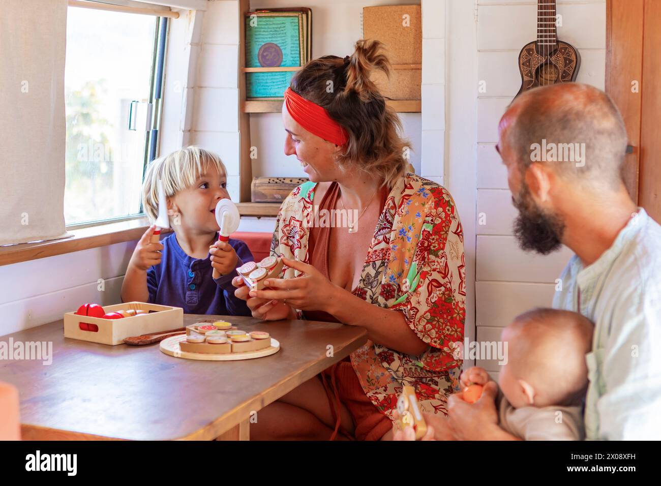 A family enjoys their nomadic lifestyle inside their van, equipped with ...
