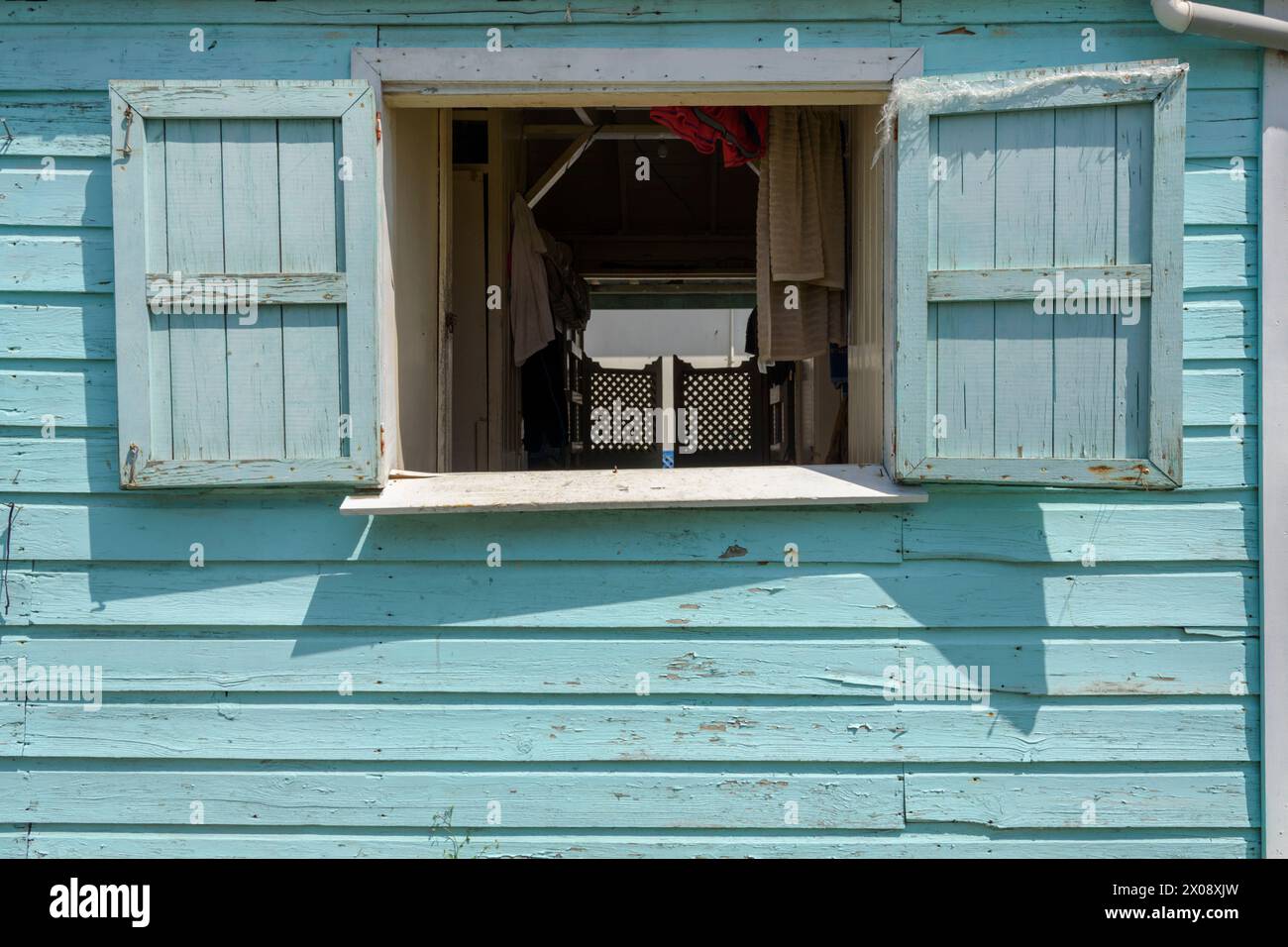 Close up of the blue painted window shutters of a traditional wooden ...