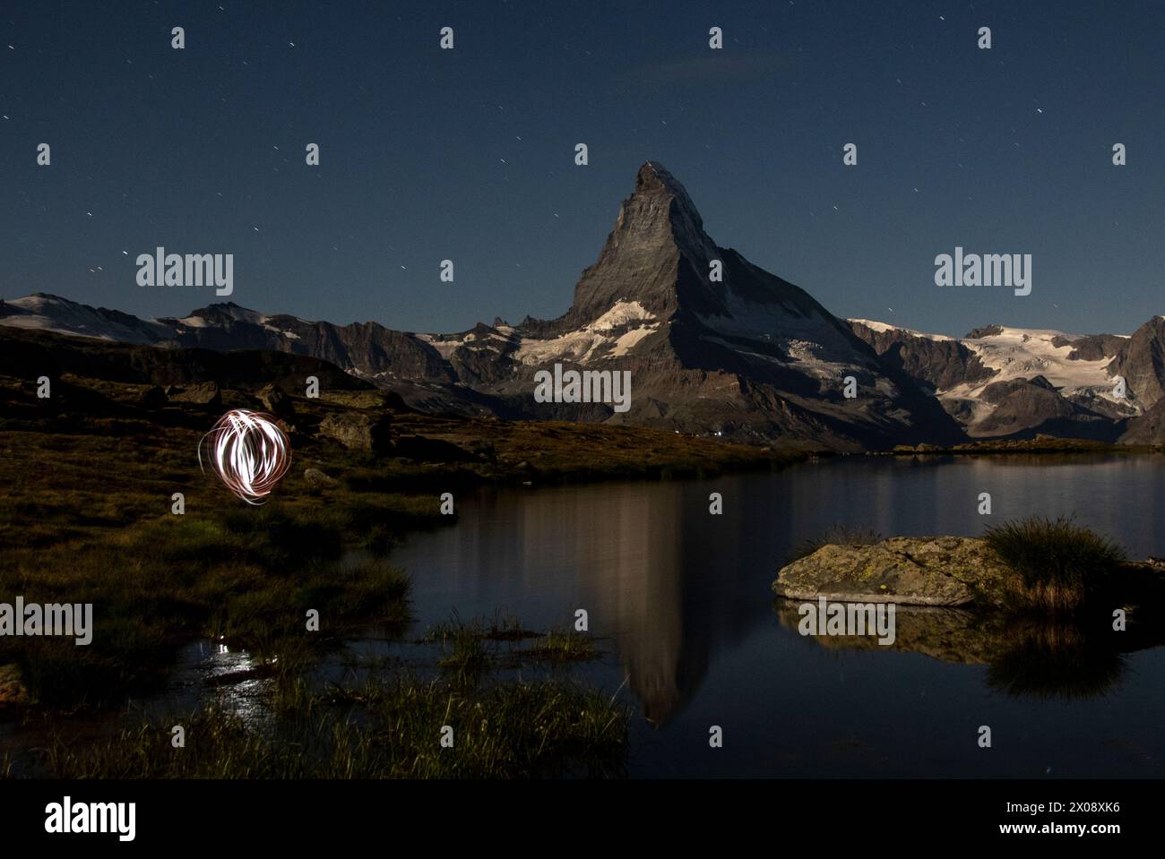 An artist creates a sphere of light through painting with a light ...