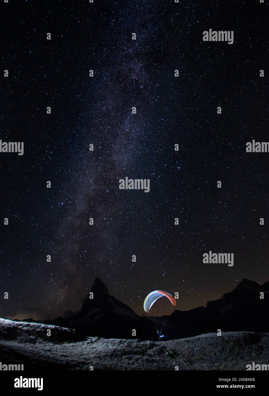 A paraglider ascends against the majestic backdrop of the Matterhorn ...
