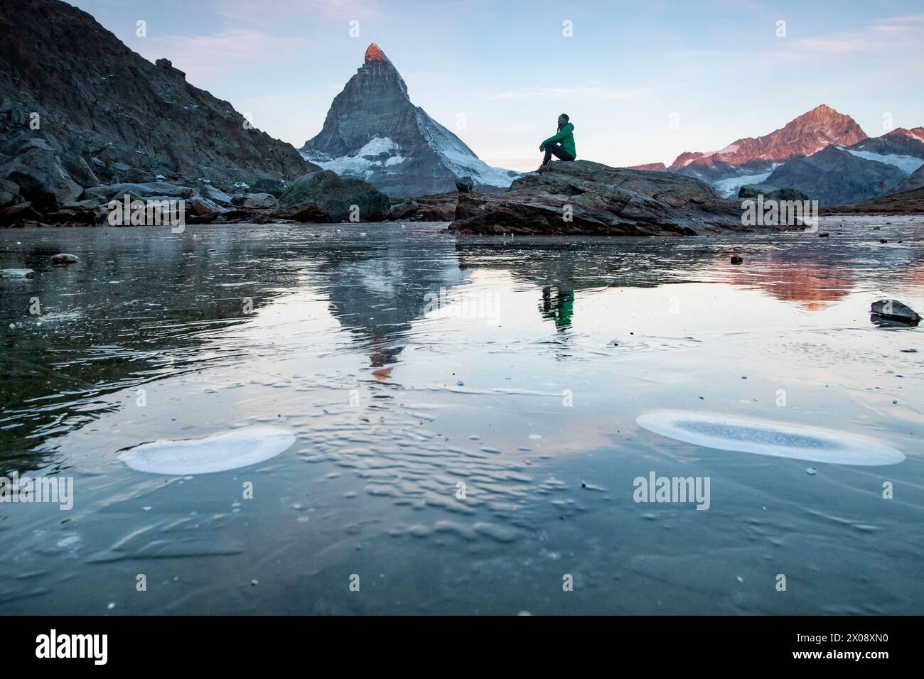 A serene spring scene depicting the thawing of a lake with clear views ...