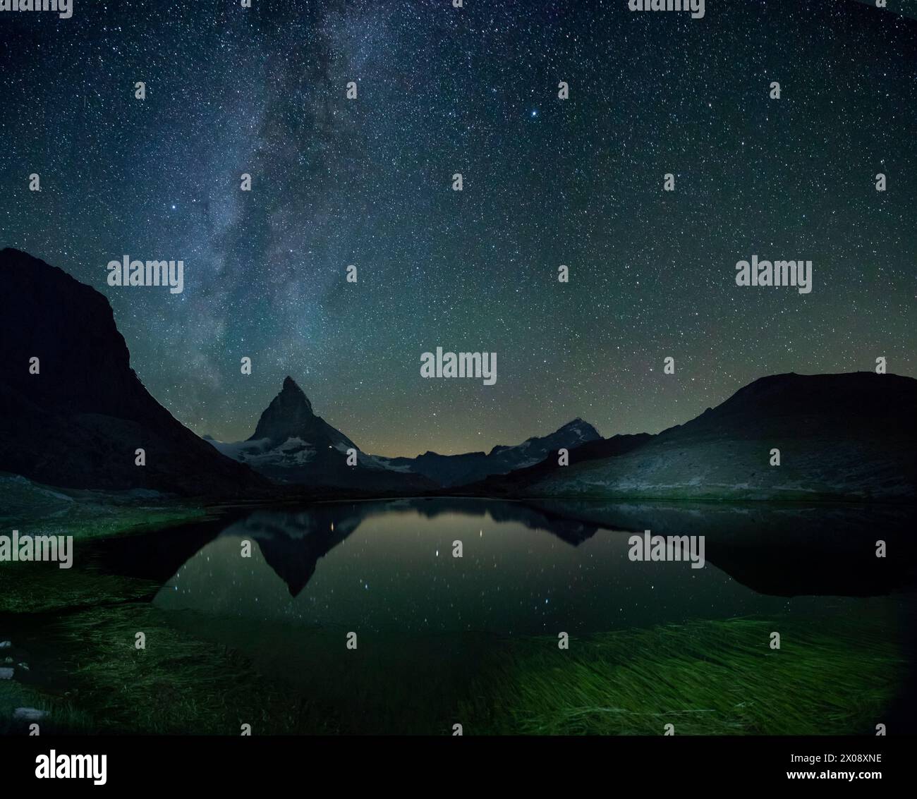 A serene night landscape captures the iconic Matterhorn mountain under ...