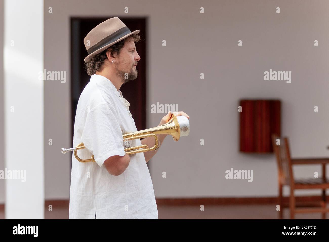 A dedicated trumpeter with one arm is immersed in his practice session ...