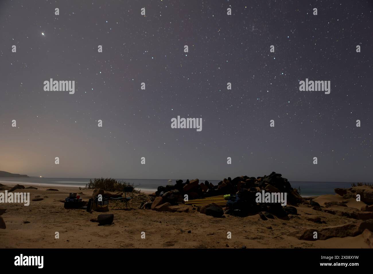 A serene star-studded night sky illuminates Cofete Beach in ...