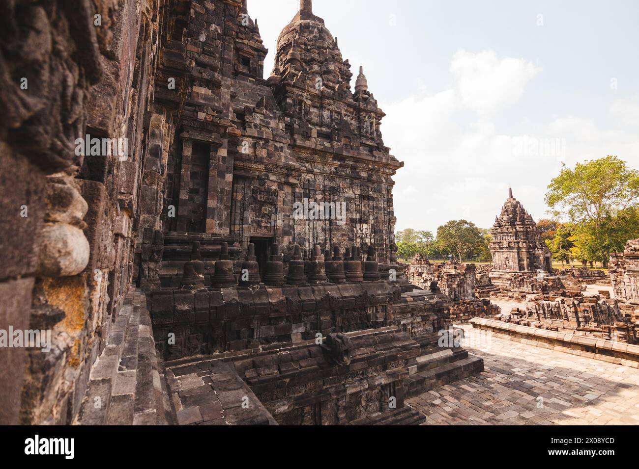 Majestic ancient temple ruins in Indonesia set against a clear blue sky ...