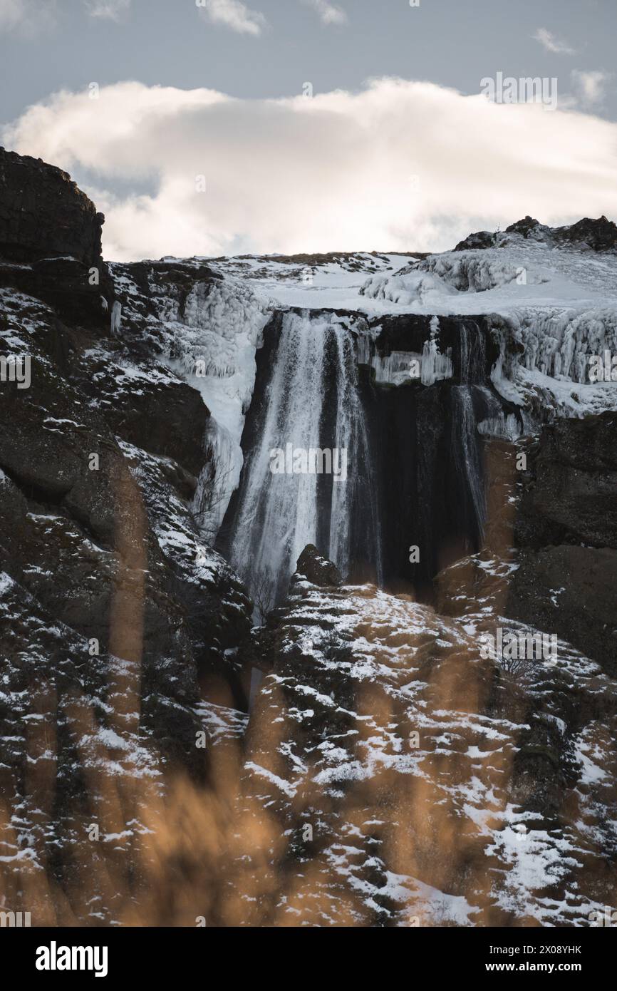 The mesmerizing sight of an Icelandic waterfall, where icy formations ...