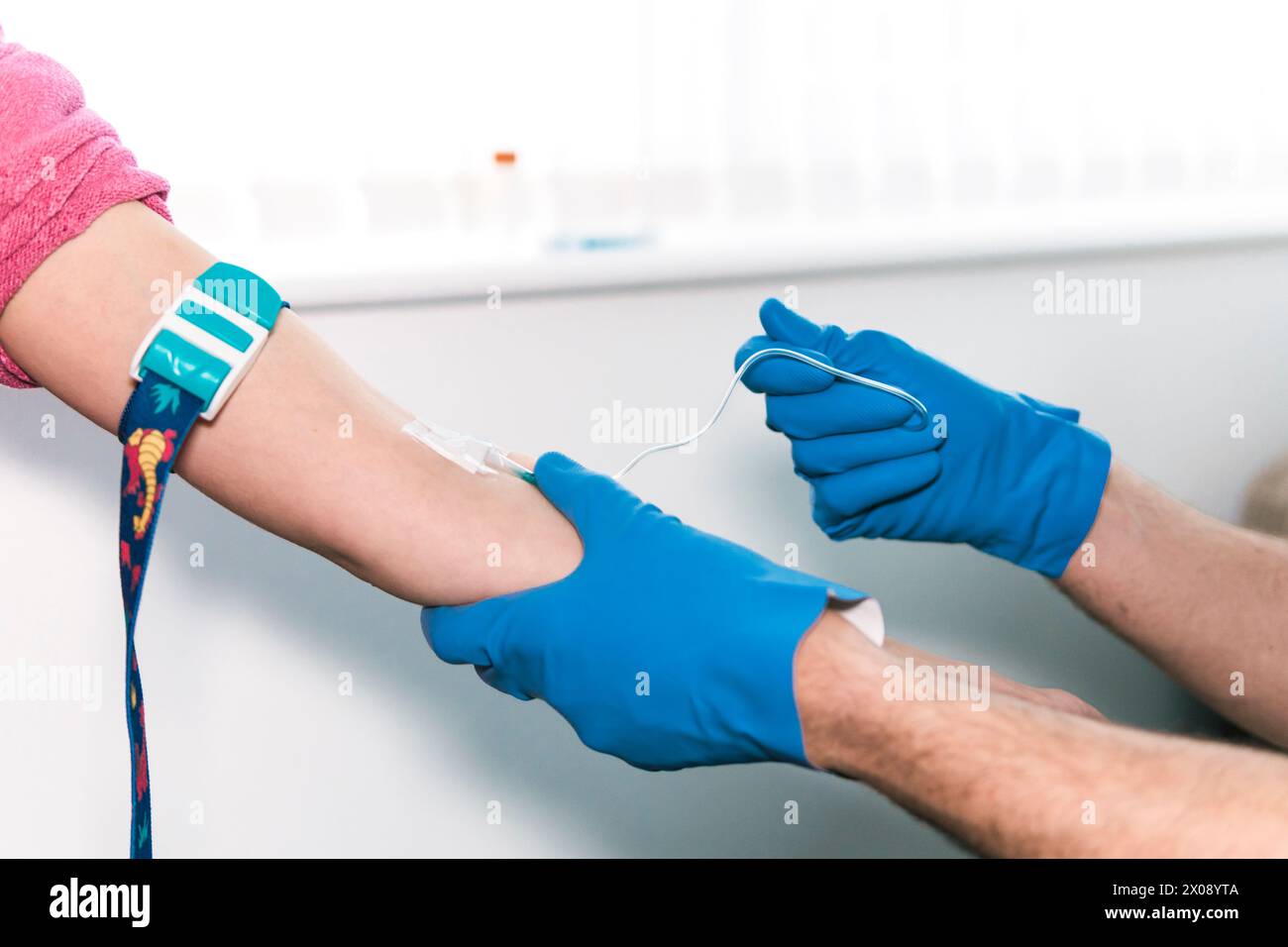 Focused healthcare anonymous professional adeptly inserts an IV ...