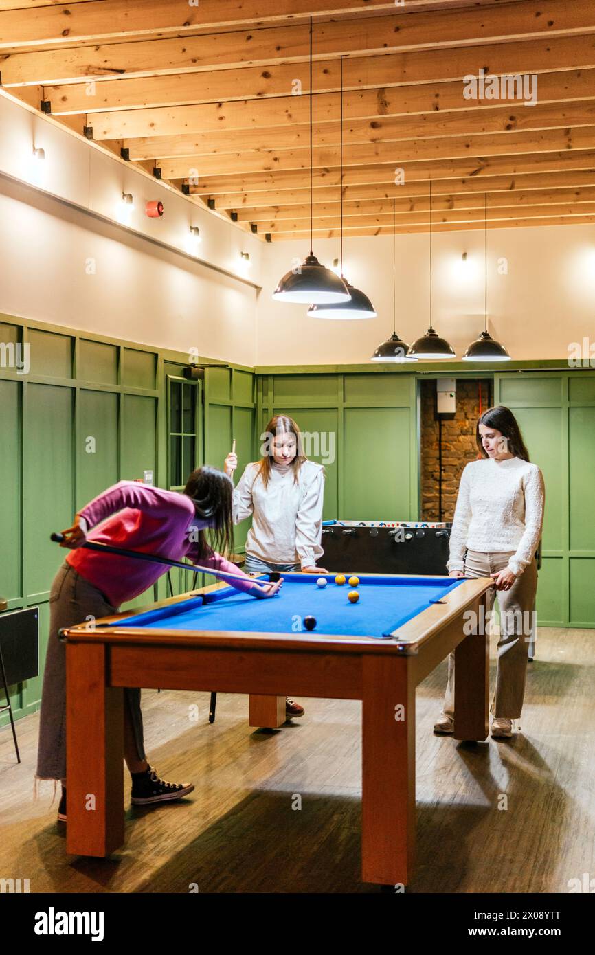 Young friends enjoying competitive pool hi-res stock photography and ...