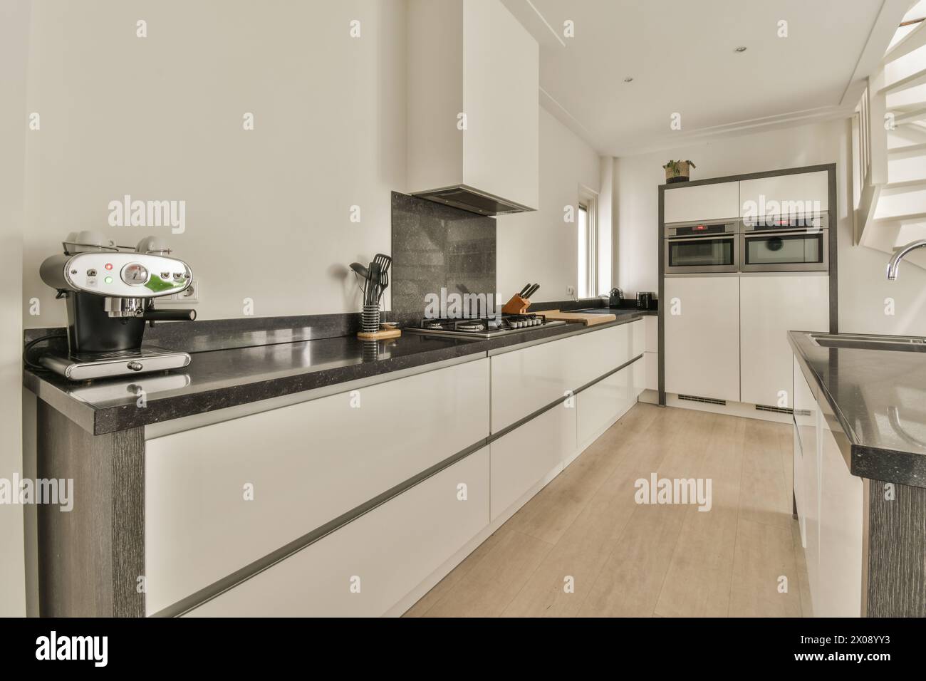 A contemporary kitchen showcasing a professional espresso machine ...