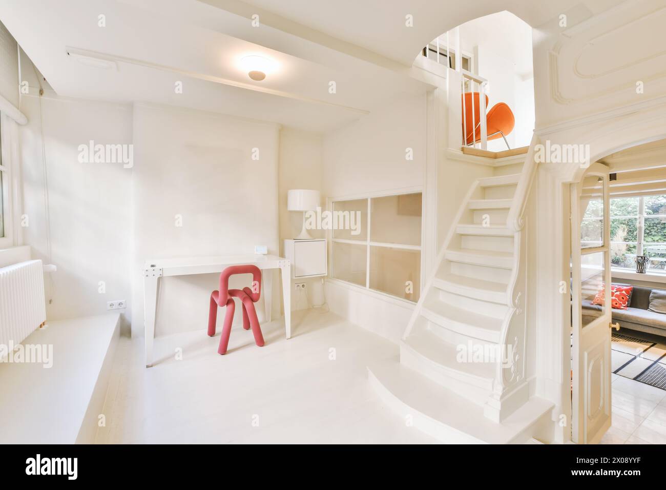 Bright and airy interior space featuring a unique staircase, a modern ...