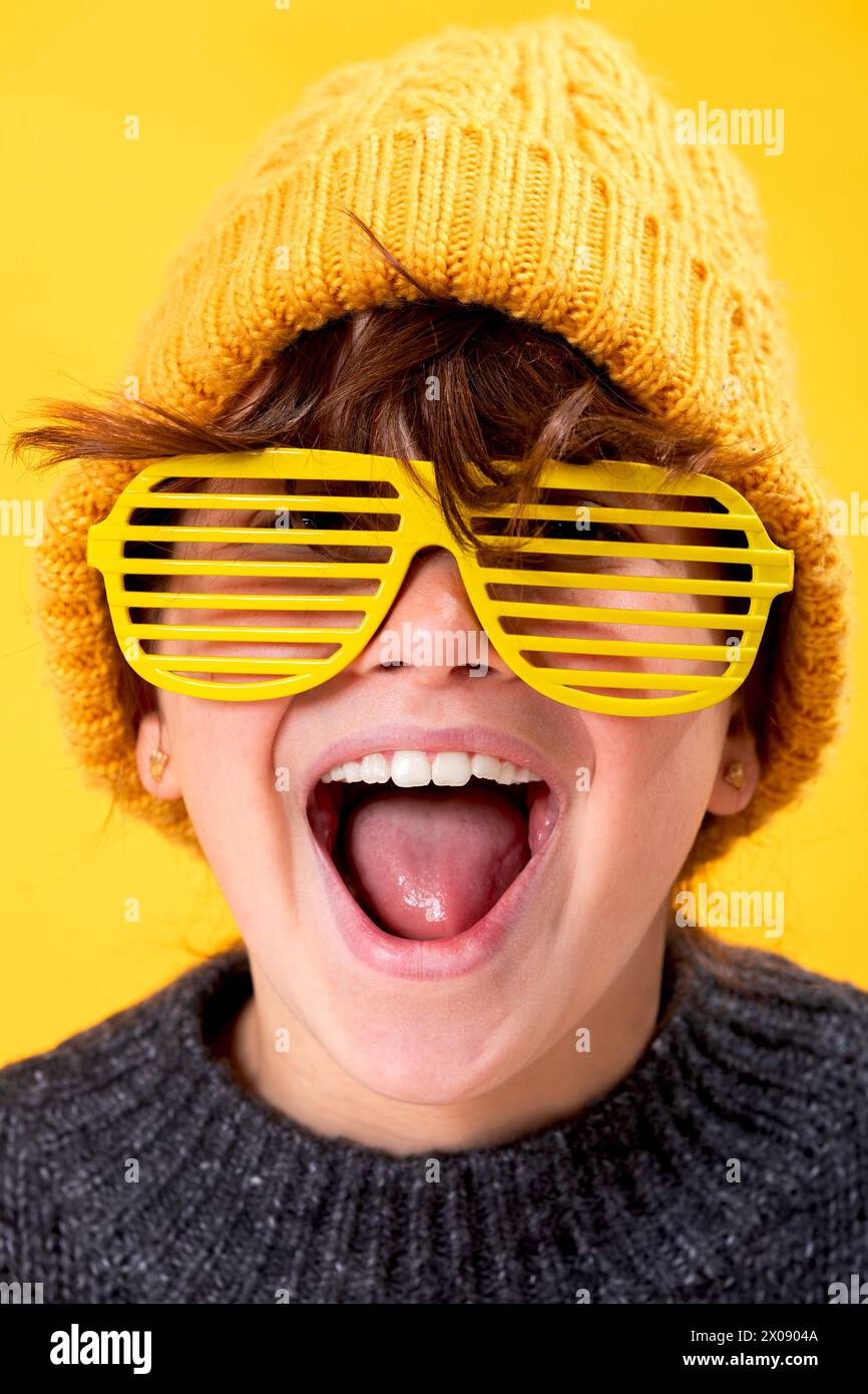 A girl radiates joy as she poses in vibrant yellow shutter shades and a ...