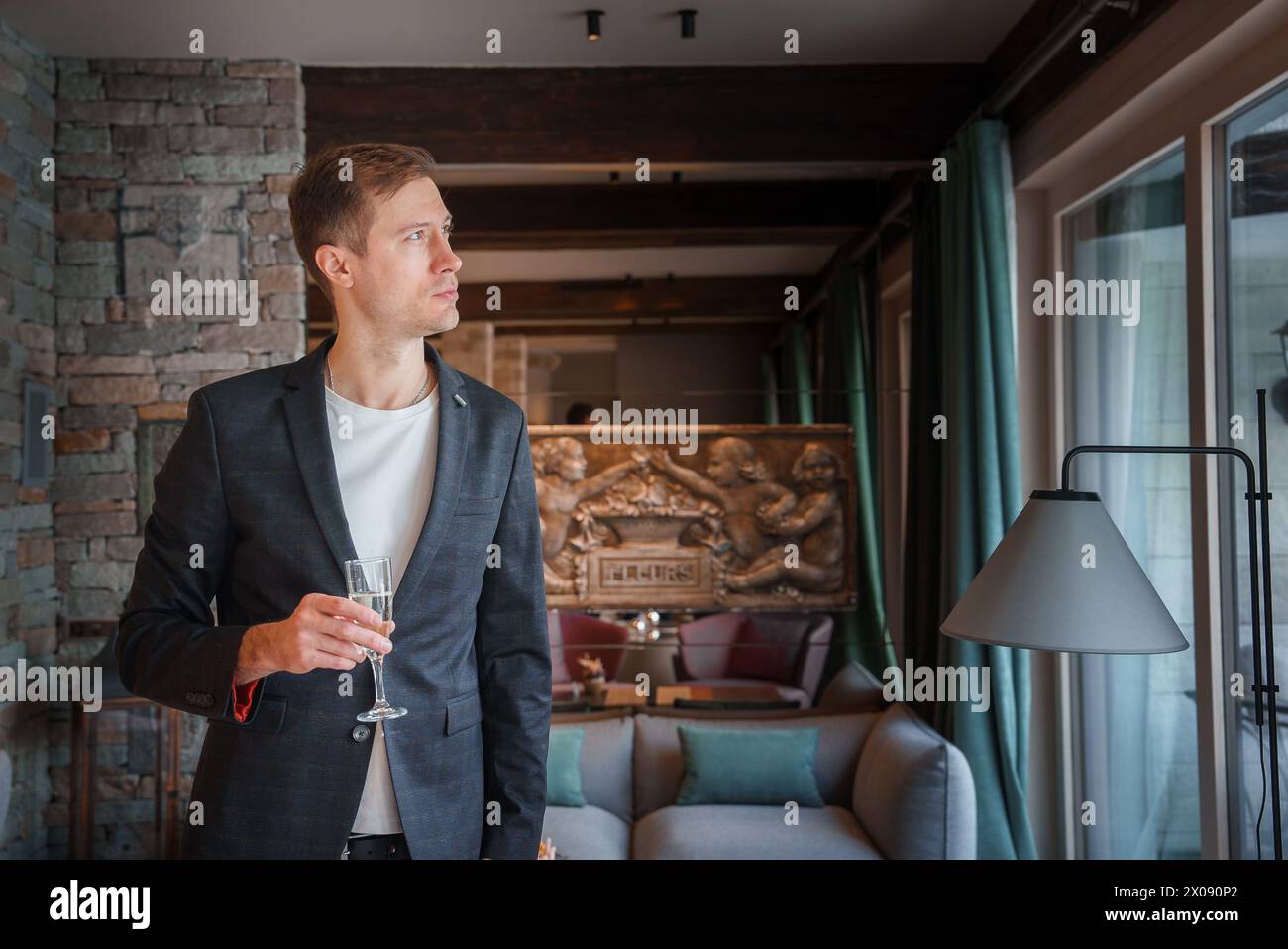 Luxury hotel scene with man in dark suit holding glass, Zermatt ...