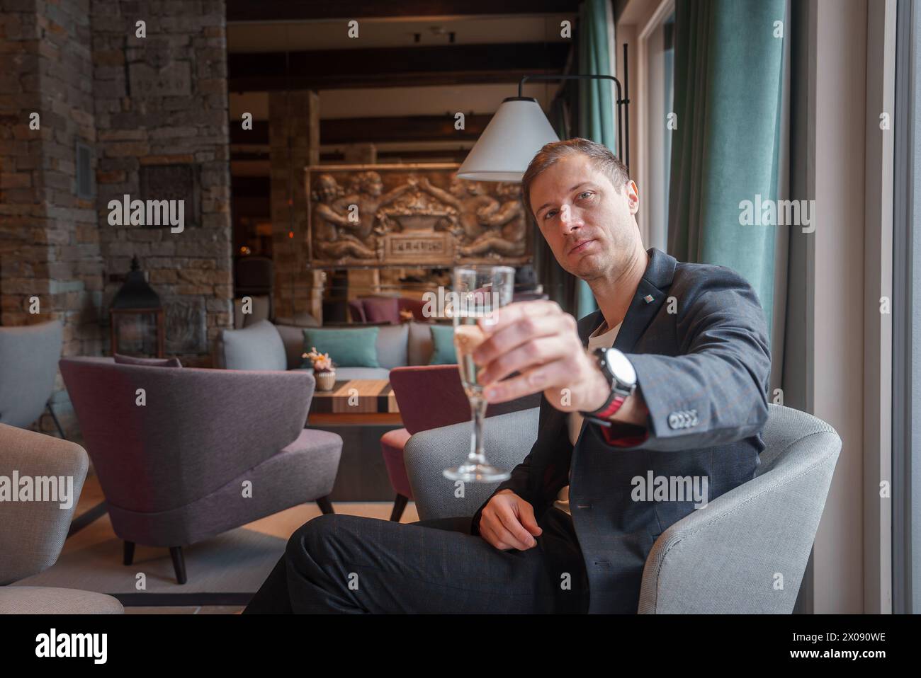 Sophisticated Man Toasting Sparkling Wine in Modern Luxury Lounge ...