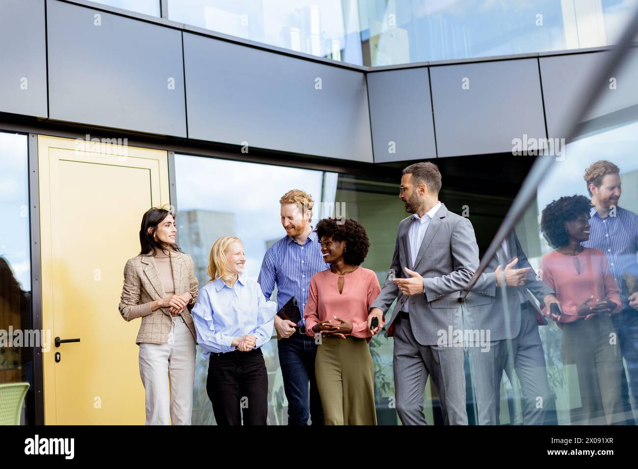 Group of colleagues in a casual business huddle, sharing ideas next to ...