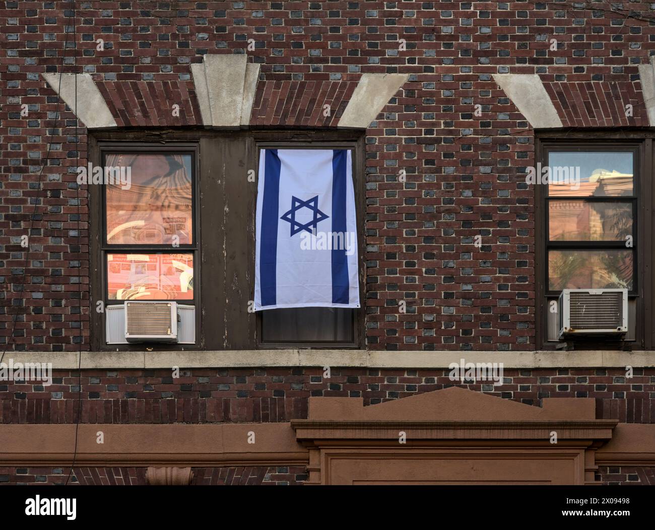 israeli flag hanging in the window of an apartment building in brooklyn ...