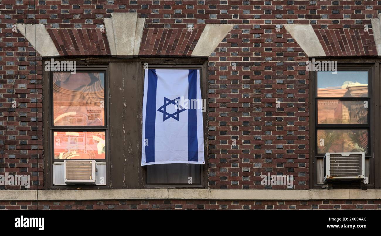 israeli flag hanging in the window of an apartment building in brooklyn ...