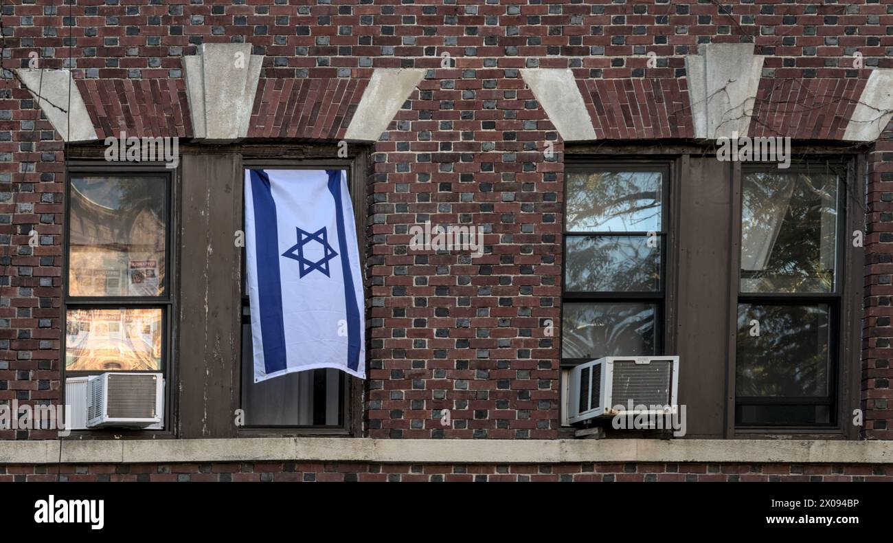 israeli flag hanging in the window of an apartment building in brooklyn ...