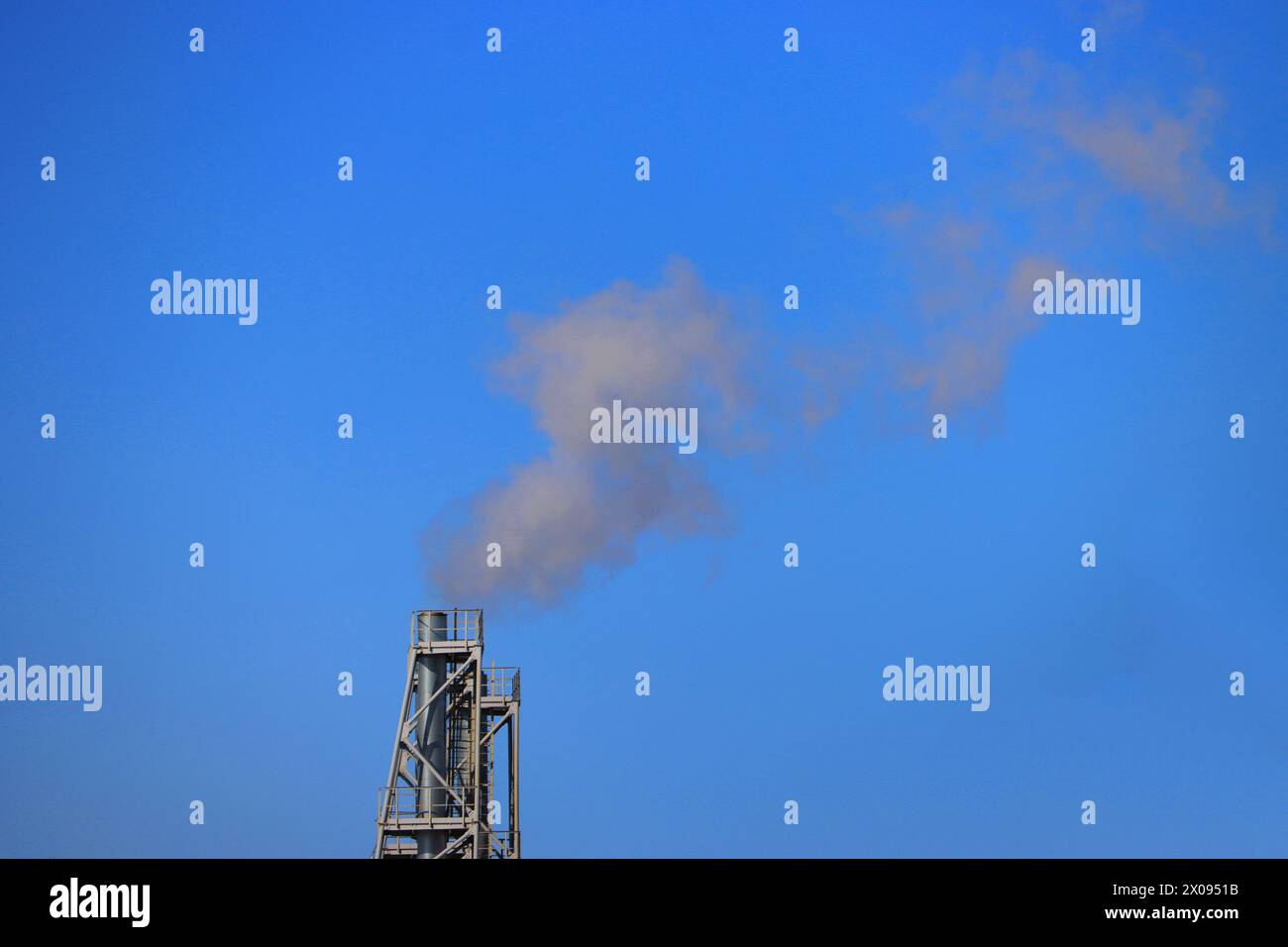 White smoke against blue sky, climate change. Factory smoke causes ...