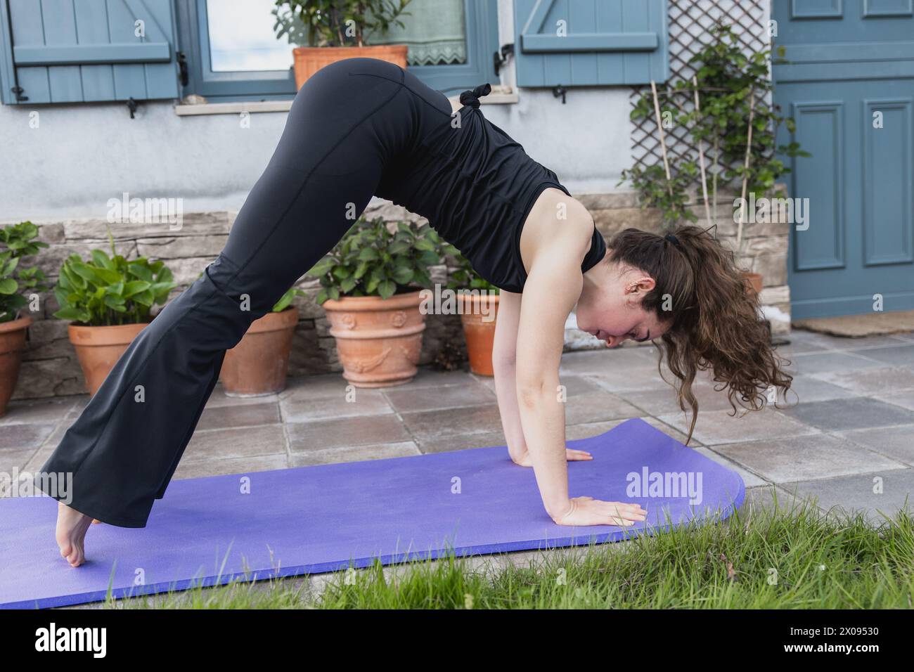 Woman channels strength and flexibility in Downward Dog pose ...